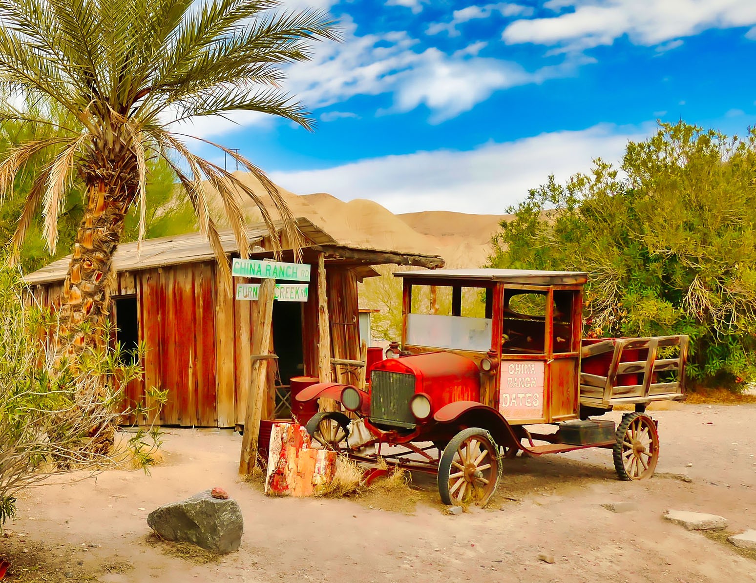 Tropical shack with tree in front, old fashioned red and white wagon ...